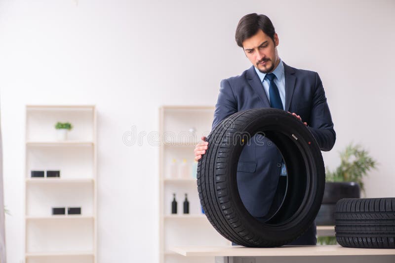 Young Man Selling Tires in the Office Stock Photo - Image of rubber ...