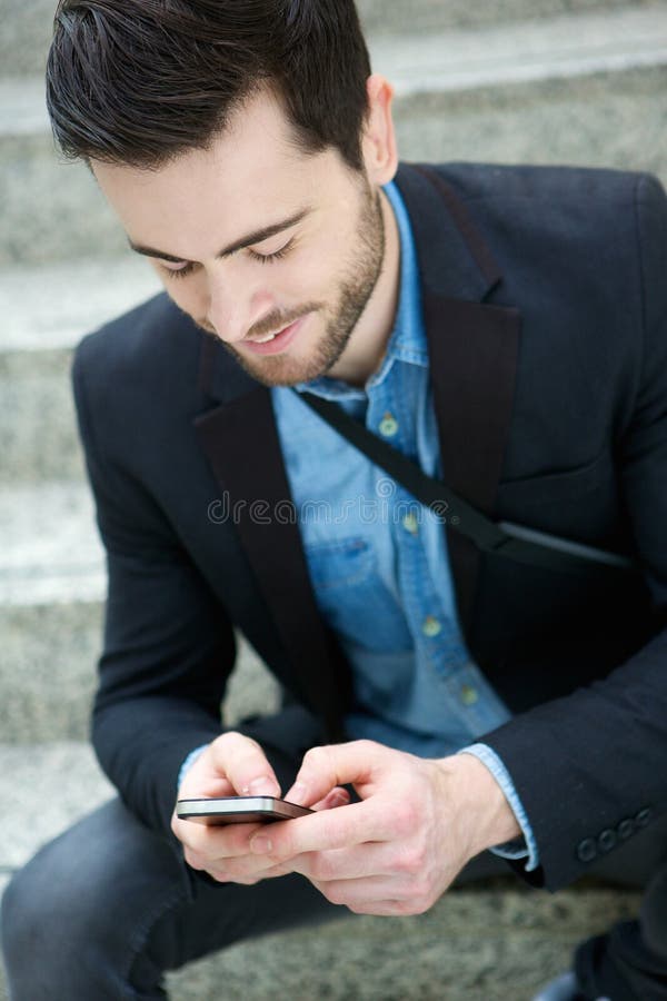 Young Man Sending Text Message Stock Photo - Image of looking, casual ...