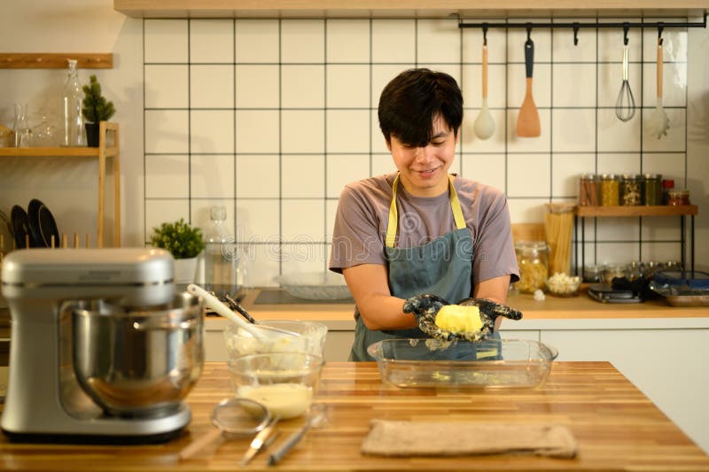 Young Man Shaping Freshly Made Butter by Hand in a Kitchen Stock Photo ...