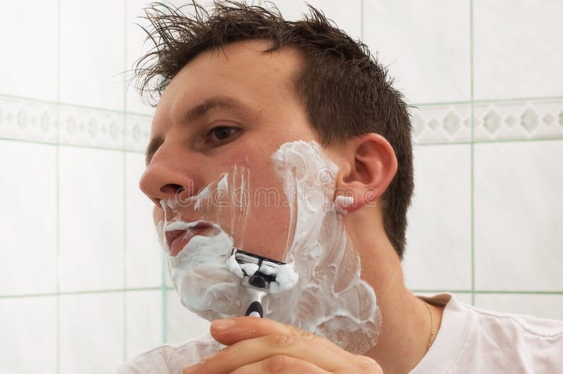 Young man is shaving stock image. Image of refreshment - 12131375