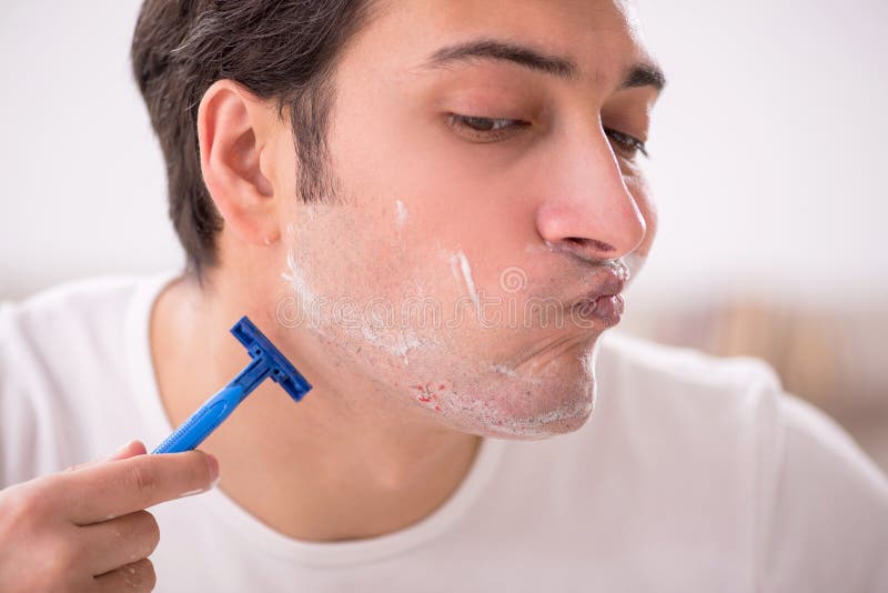 Young Man Shaving Face at Home Stock Image - Image of skin, looking ...