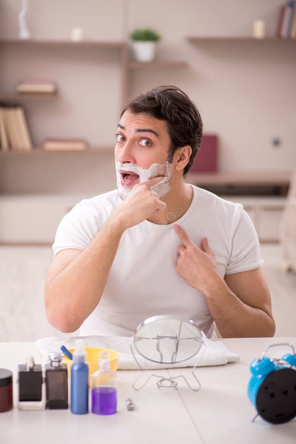 Young Man Shaving Face at Home Stock Photo - Image of bathroom, hair ...