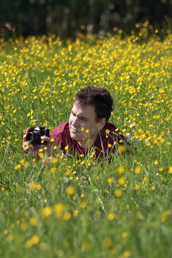 Young Man Shoots among Yellow Flowers at Meadow Stock Image - Image of ...
