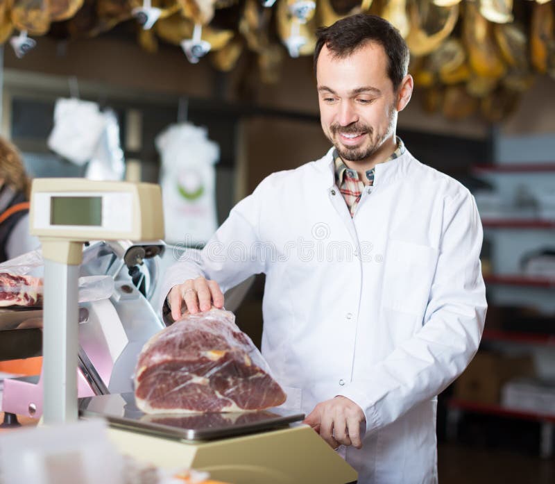 Young Man Shop Assistant Using Scales for Meat in Butcher Shop Stock ...