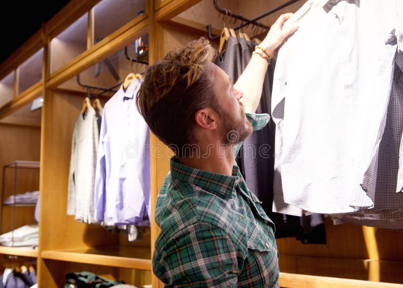 Young Man Shopping for Clothes in Store Stock Photo - Image of ...
