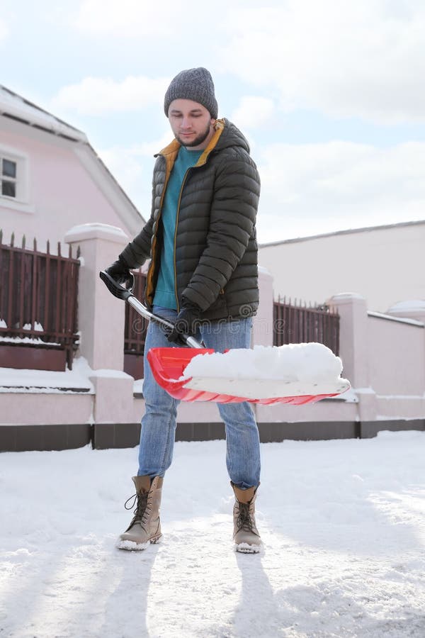 Young Man Shoveling Snow Outdoors on Winter Day Stock Photo - Image of ...
