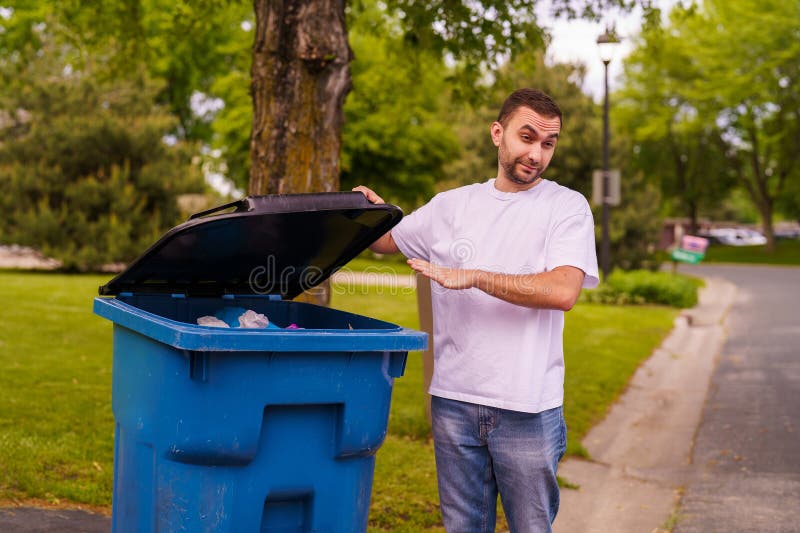 Young Man Show Bad Smell Emanating Inside Large Plastic Mobile Trash ...