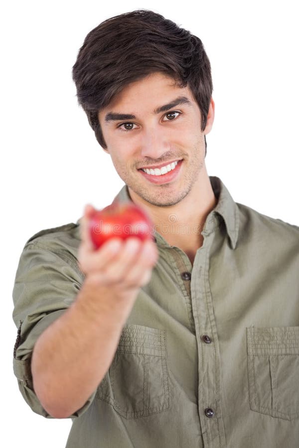 Young man showing an apple stock image. Image of cheerful - 32510823