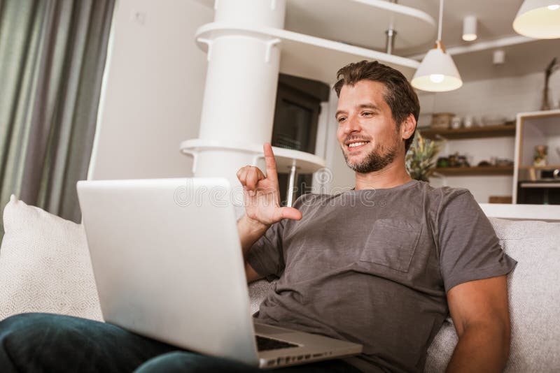 Man Showing Gesture in Sign Language, Using Laptop Stock Photo - Image ...