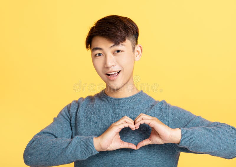 Young Man Showing Hand Sign Heart on His Chest Stock Image - Image of ...