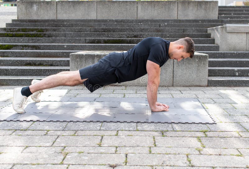 Young Man Doing a Triangle Push-up or Diamond Push-up Outdoors on an ...