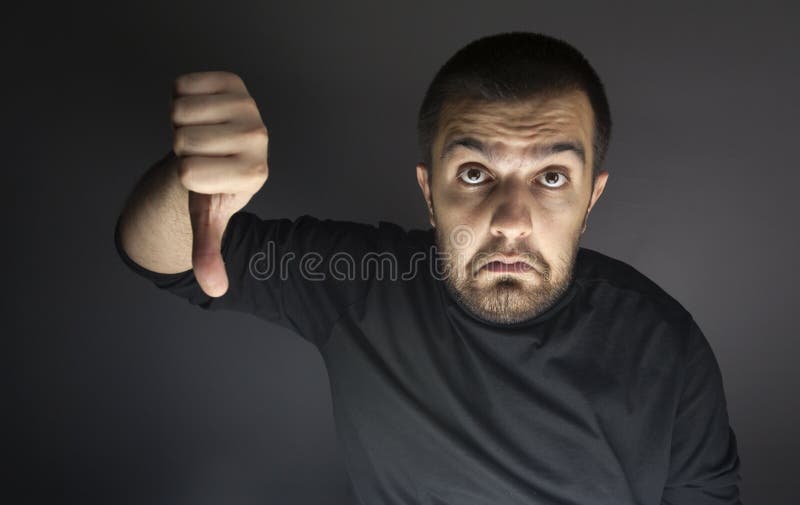 Young man thumbs down stock image. Image of people, thumb - 110649099
