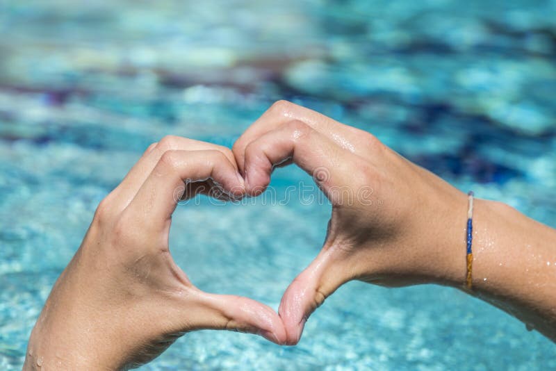 Young Man Shows Love Sign with Heart Shape Formed by Hands Stock Photo ...