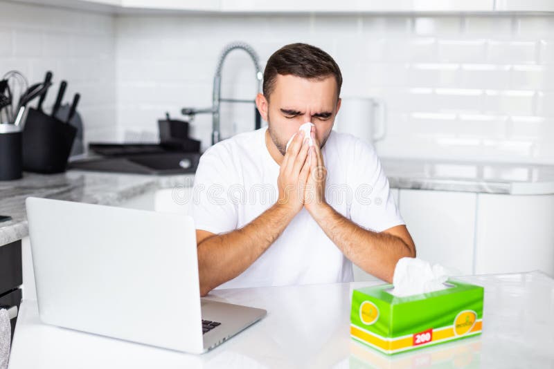 Young Man Sick Man Sneeze Nose Working on His Laptop in the Kitchen ...