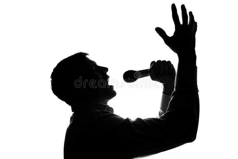 A Young Man Singing into a Microphone Raising His Hands Stock Image ...