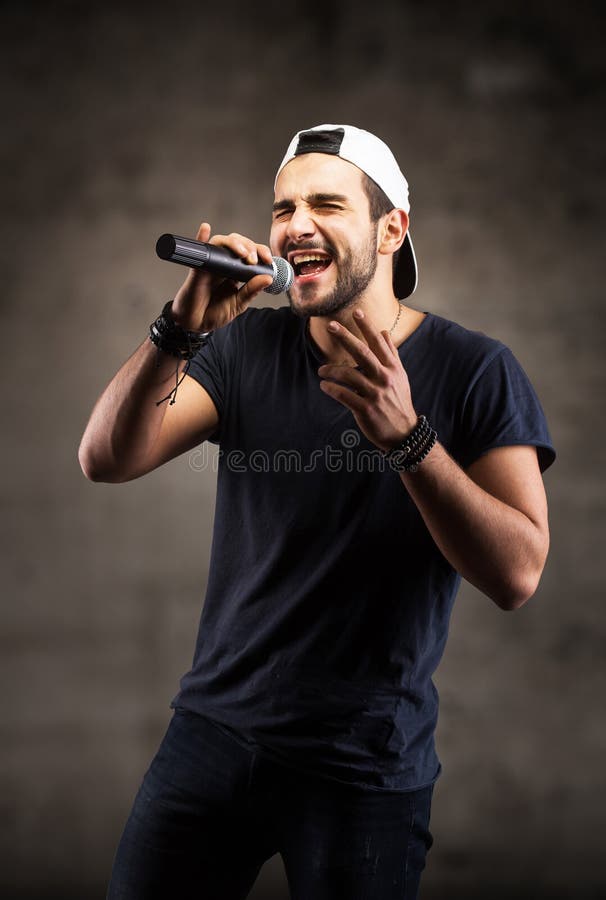 Young Man Singing into a Microphone Stock Photo - Image of scream ...