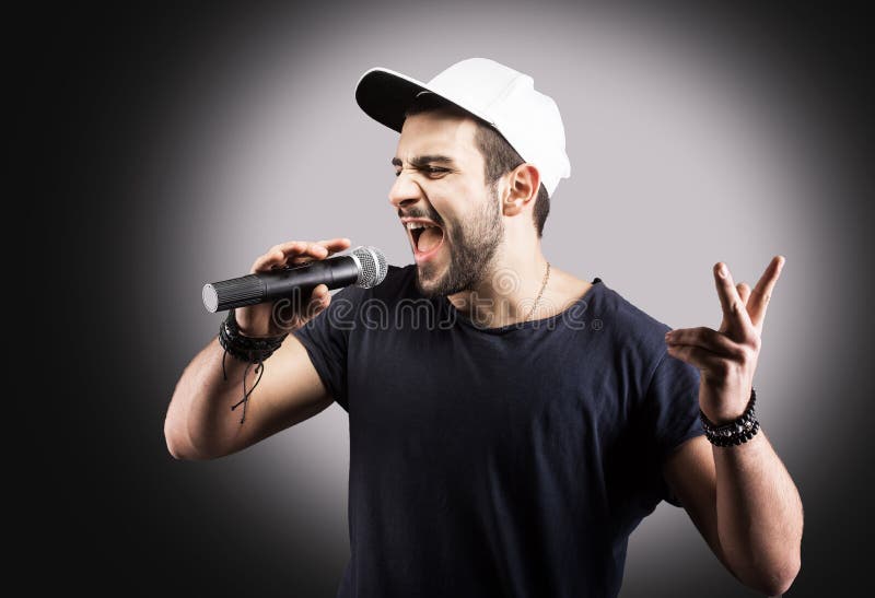 Young Man Singing into a Microphone Stock Photo - Image of eyes, music ...