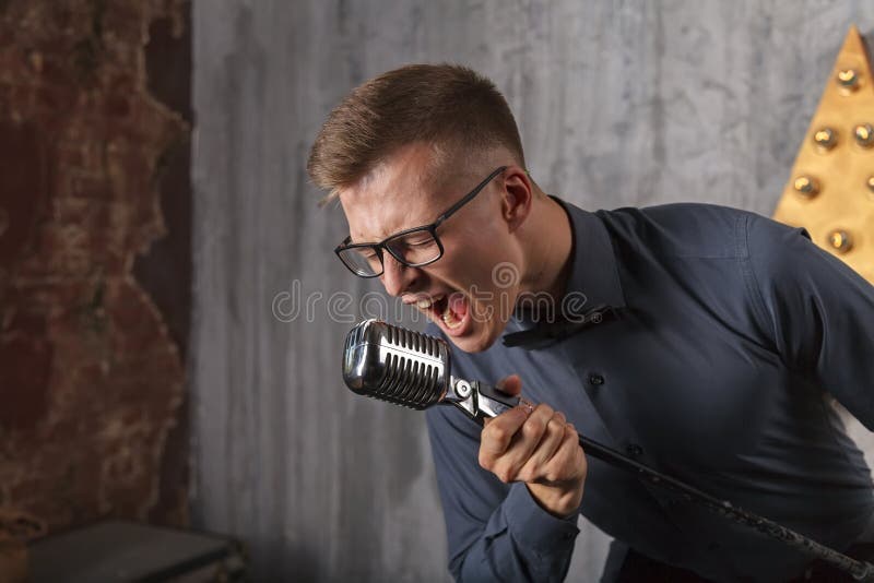 Young Man Singing with Microphone Stock Image - Image of glamour ...