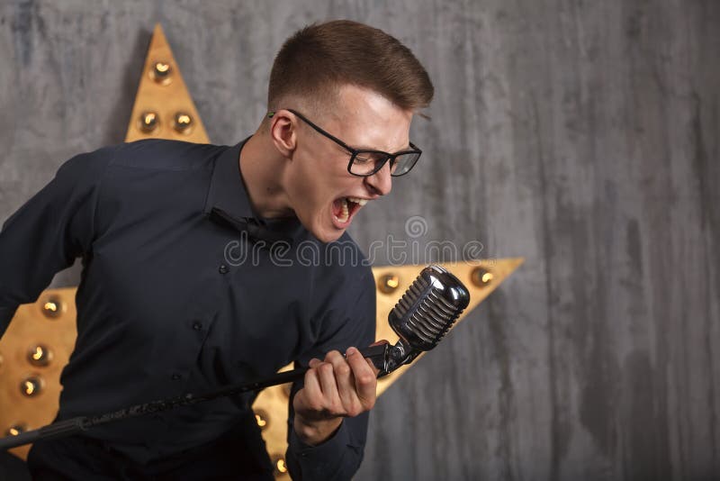 Young Man Singing with Microphone Stock Image - Image of attractive ...