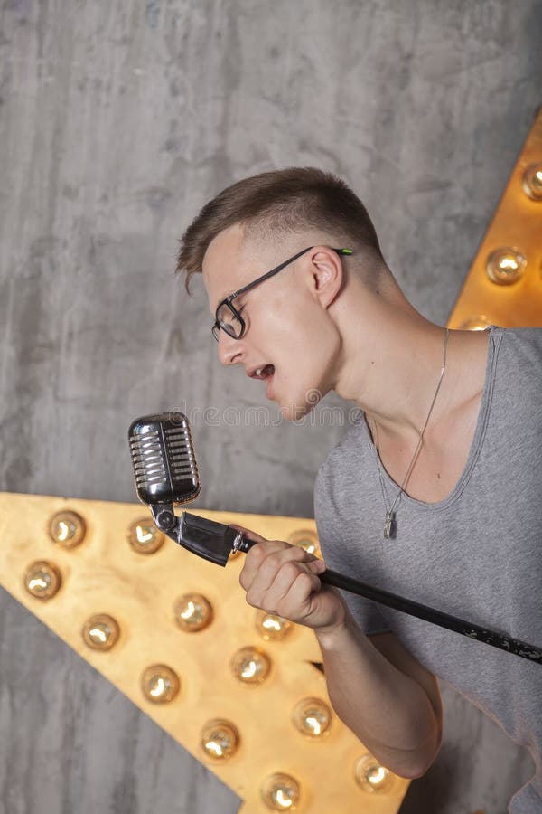 Young Man Singing with Microphone Stock Image - Image of artist, singer ...