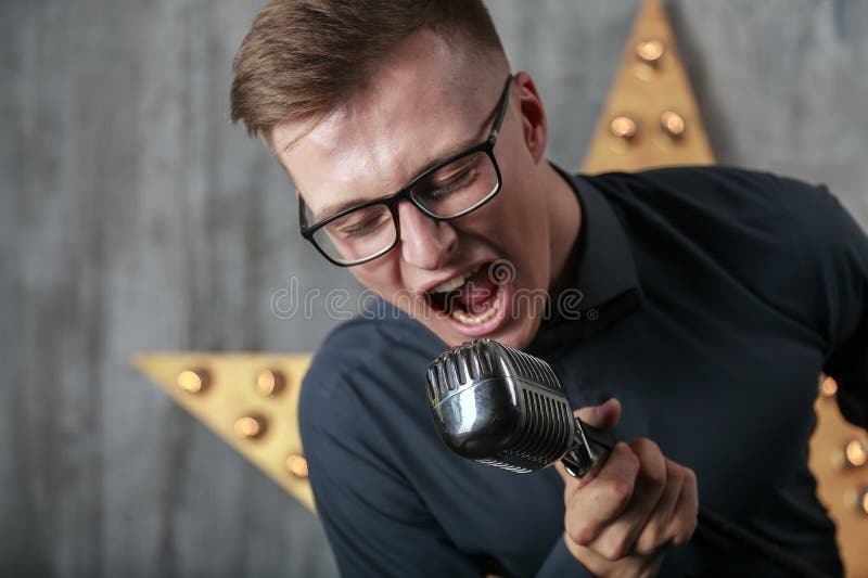 Young Man Singing with Microphone Stock Image - Image of artist, singer ...