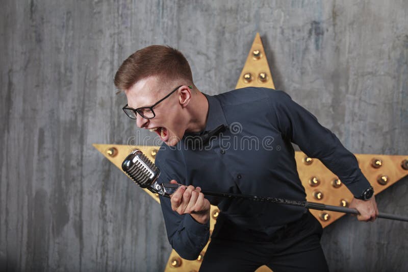 Young Man Singing with Microphone Stock Image - Image of artist, singer ...