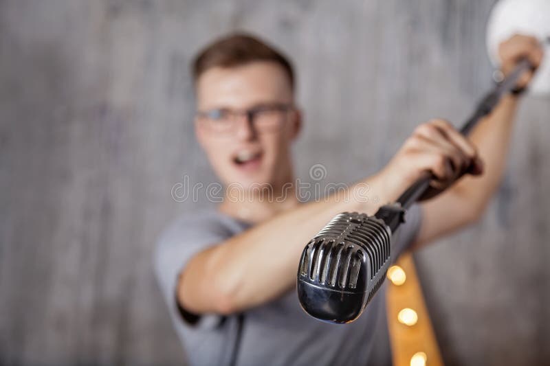 Young Man Singing with Microphone Stock Image - Image of artist, singer ...