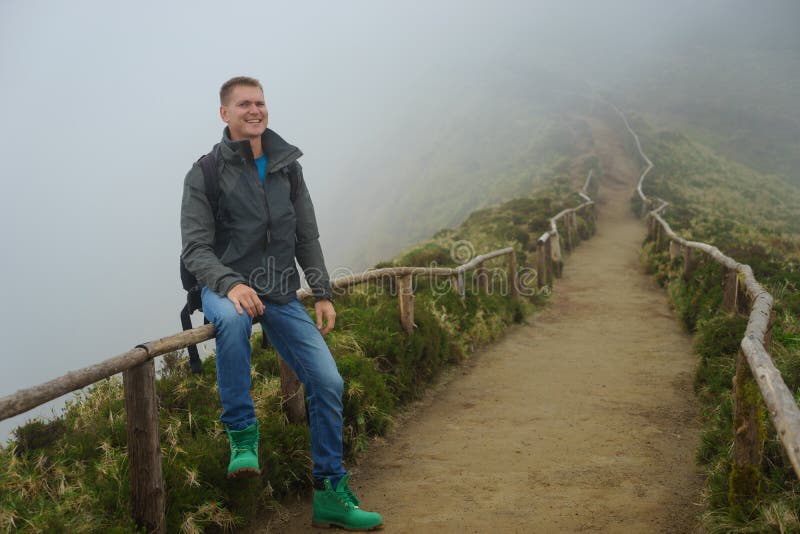 A Young Man Sits at the Edge of a Path Stock Photo - Image of trekking ...
