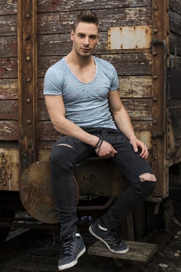 Young Man Sitting Against Old Rusty Train Stock Image - Image of ...