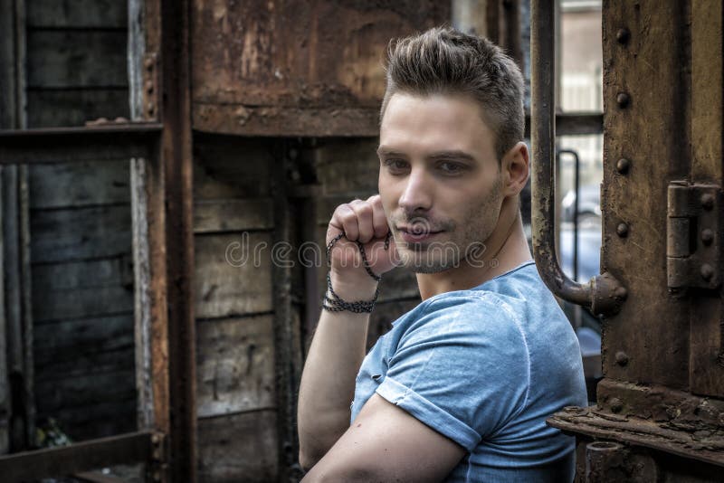Young Man Sitting Against Old Rusty Train Stock Photo - Image of haired ...