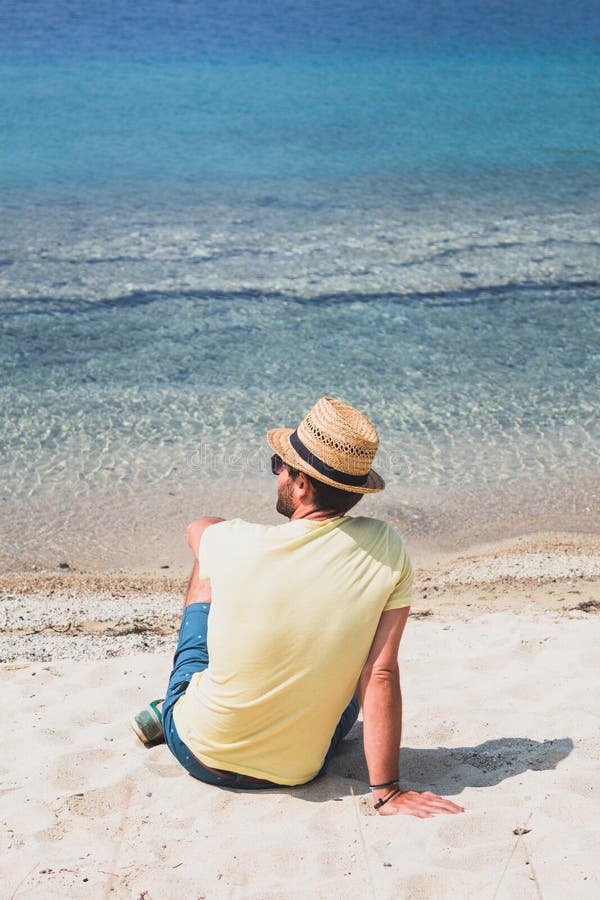 Young Man Sitting on the Beach Stock Photo - Image of lifestyle ...