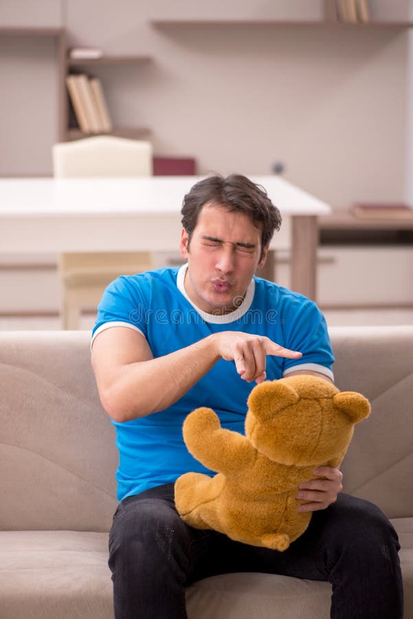 Young Man with Toy Bear at Home Stock Photo - Image of distancing, play ...