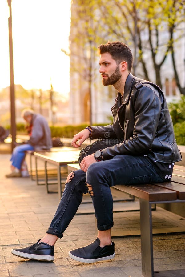 Young Man Sitting on a Bench Stock Photo - Image of sitting, handsome ...