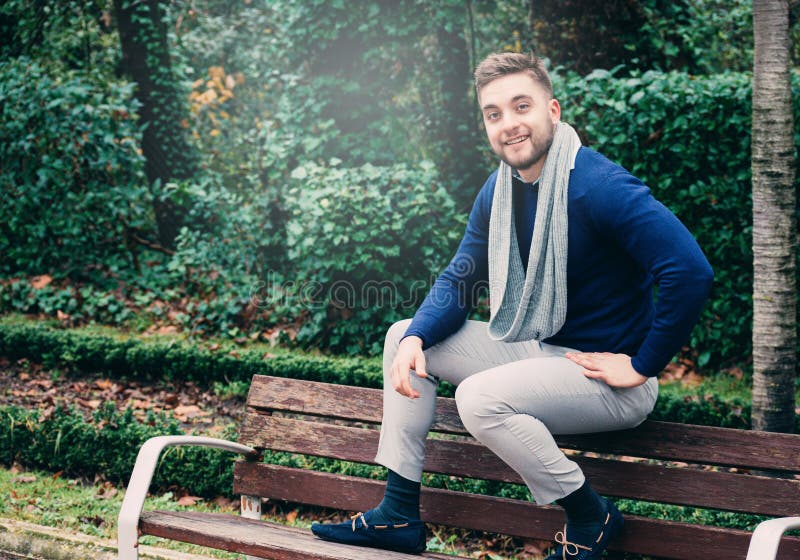 Young Man Sitting on a Bench Looking at Camera Stock Image - Image of ...