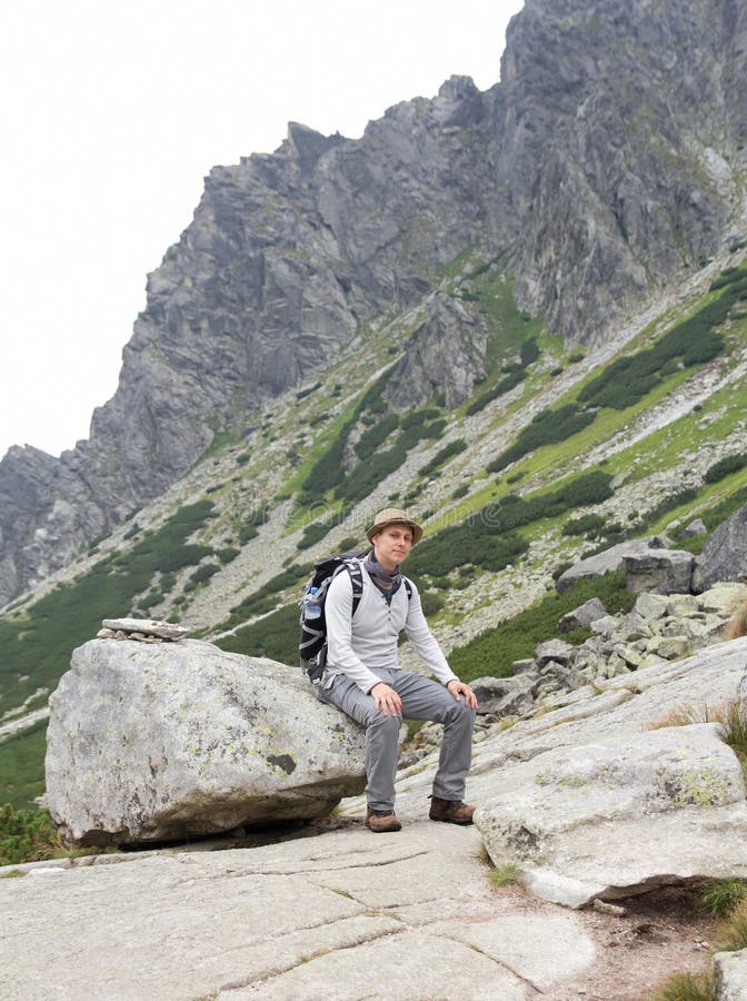 Young Man Sitting on Big Rock in Mountains Stock Image - Image of young ...