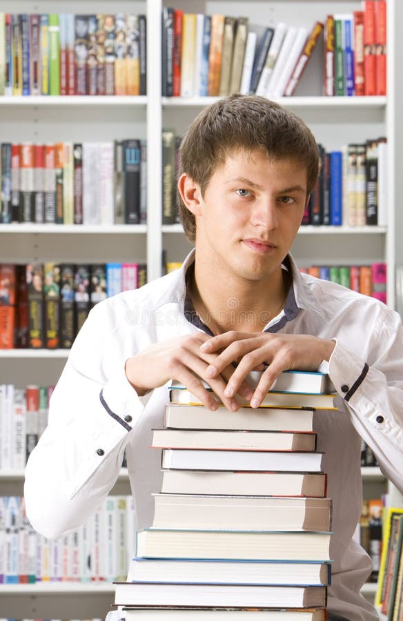 Young Man Sitting with Books Stock Photo - Image of sitting, bookshop ...
