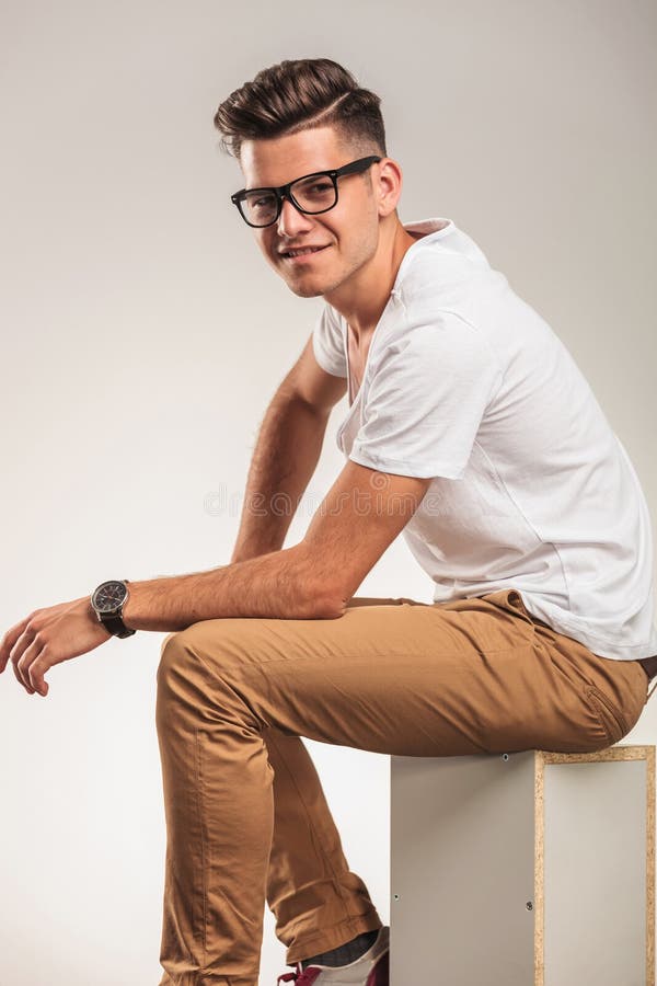 Young Man Sitting on a Box while Wearing Glasses Stock Photo - Image of ...