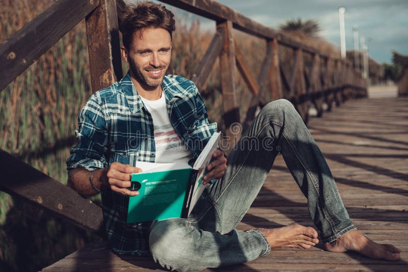 Young Man Sitting on a Bridge Stock Image - Image of modern, natural ...