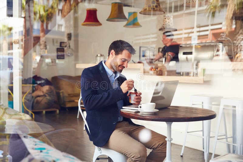 Young Man Sitting in a Cafe Eating a Dessert Stock Photo - Image of ...