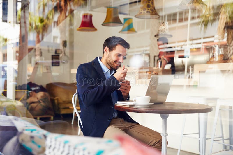 Young Man Sitting in a Cafe Eating a Dessert Stock Photo - Image of ...