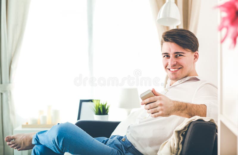 Young Man Sitting in Chair and Working on Laptop Computer Stock Image ...