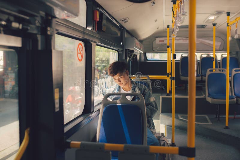 Young Man Sitting in City Bus and Reading a Book. Stock Photo - Image ...