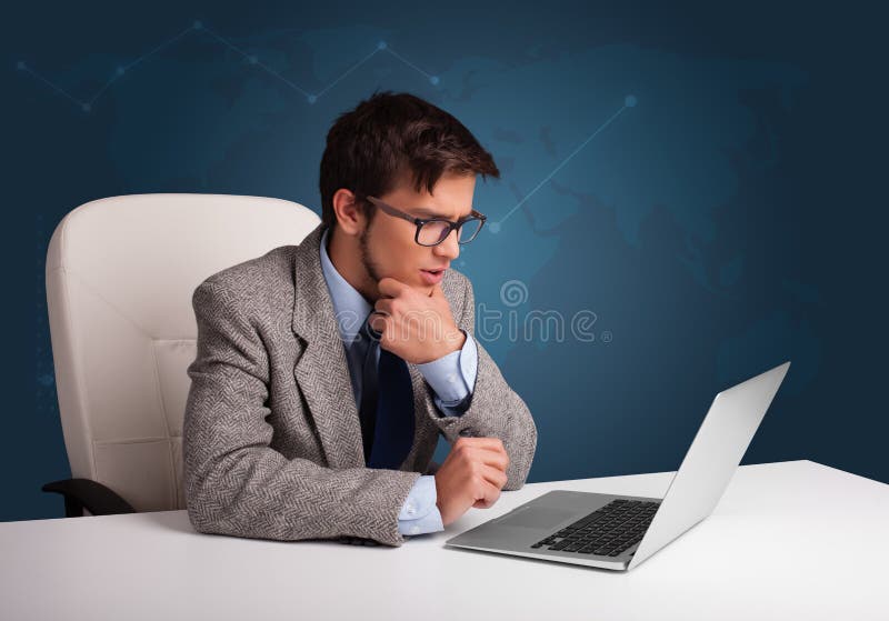Young Man Sitting at Desk and Typing on Laptop Stock Photo - Image of ...