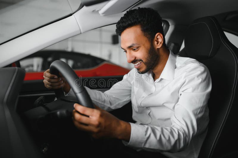 Young Man Sitting Inside New Car. Smiling Stock Photo - Image of ...