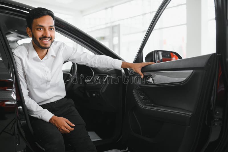 Young Man Sitting Inside New Car. Smiling Stock Photo - Image of ...