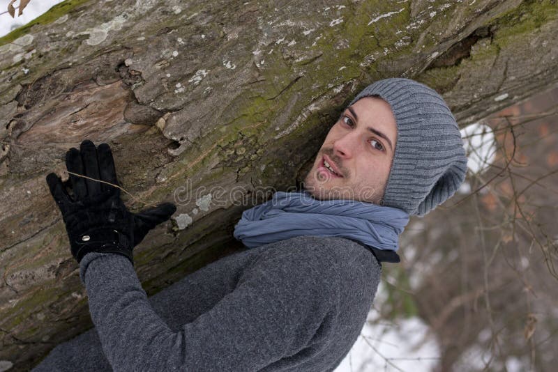Young Man Sitting Next To a Tree Stock Image - Image of outdoors, youth ...