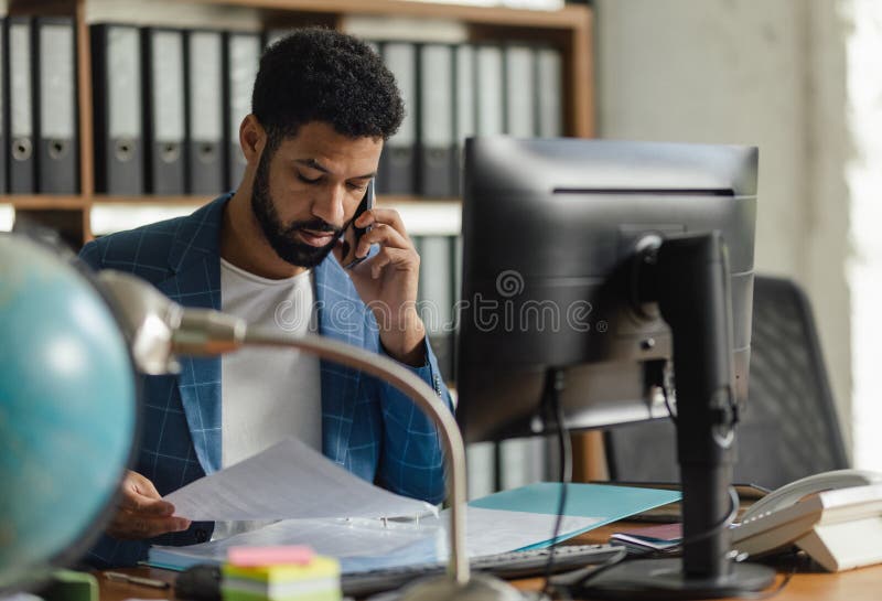 Young Man Sitting in Office and Working. Stock Image - Image of young ...
