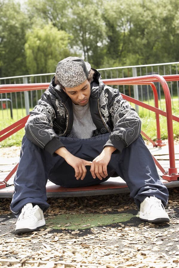 Young Man Sitting in Playground Stock Photo - Image of unhappy ...