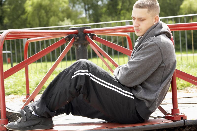 Young Man Sitting in Playground Stock Photo - Image of outdoors ...