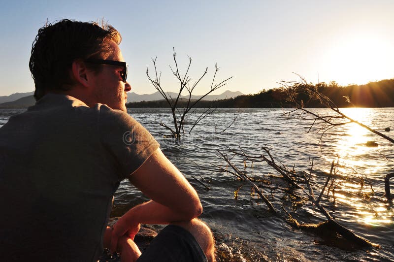 Young Man Sitting Quietly beside Lake Stock Photo - Image of lonely ...